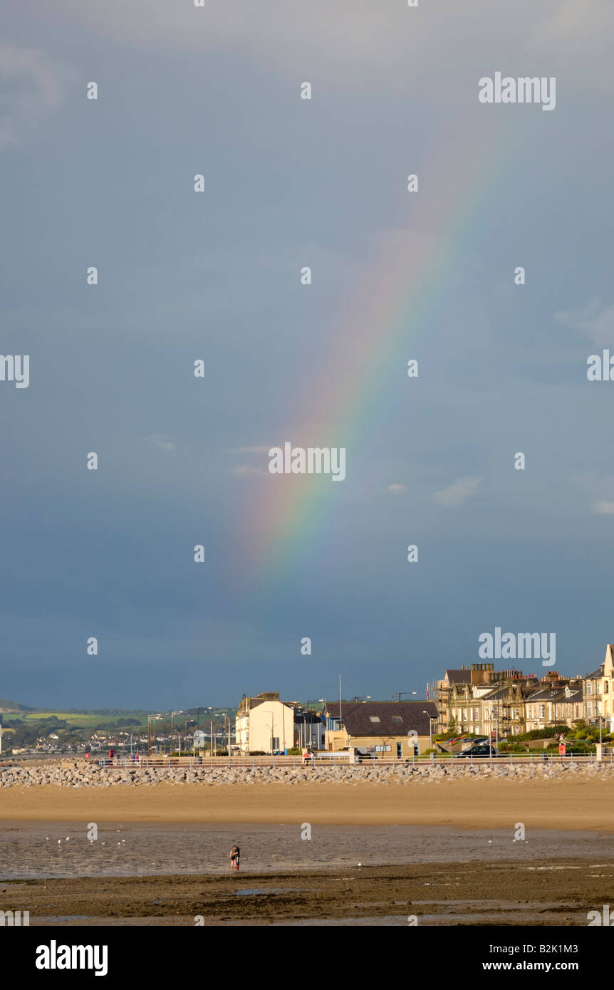 Morecambe seafront and beach with passing storm clouds and rainbow ...