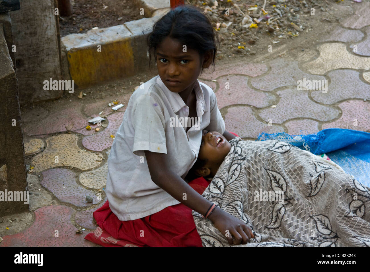 Young Homeless Girl Caring for her Sick Brother in Mumbai India Stock ...