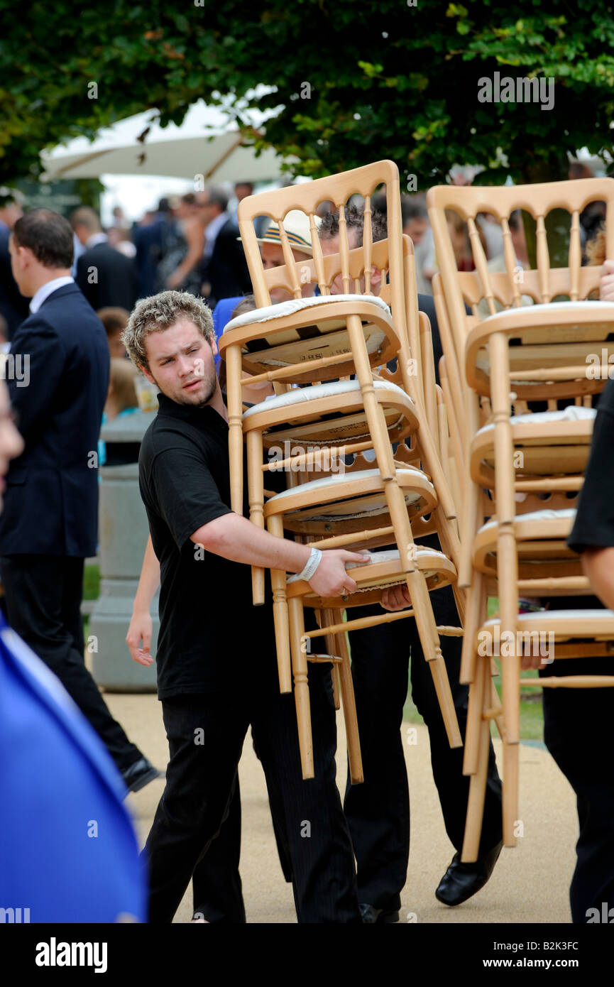 Glorious Goodwood: restaurant staff carry extra chairs for diners Stock ...