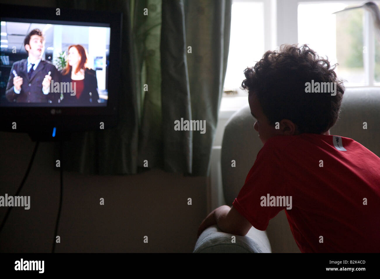 Young boy watching television Stock Photo - Alamy