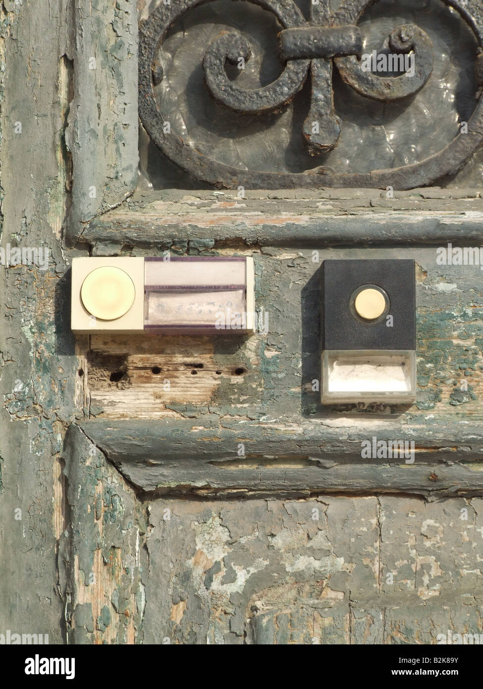 two push button door bells on old green door Stock Photo - Alamy