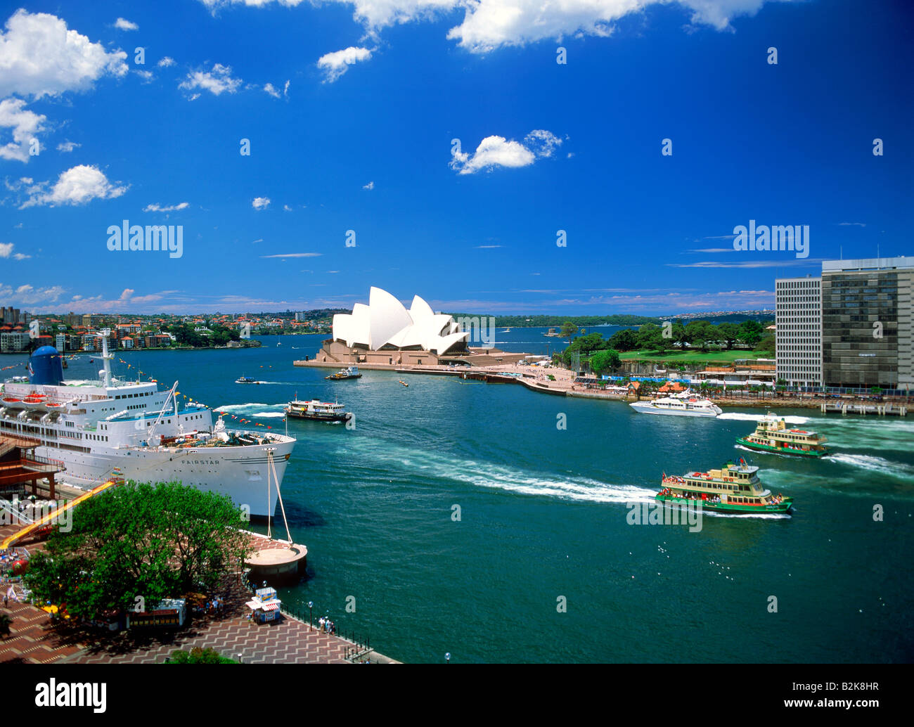 Passenger ship and ferryboats at the Sydney Harbor Quay with Opera ...