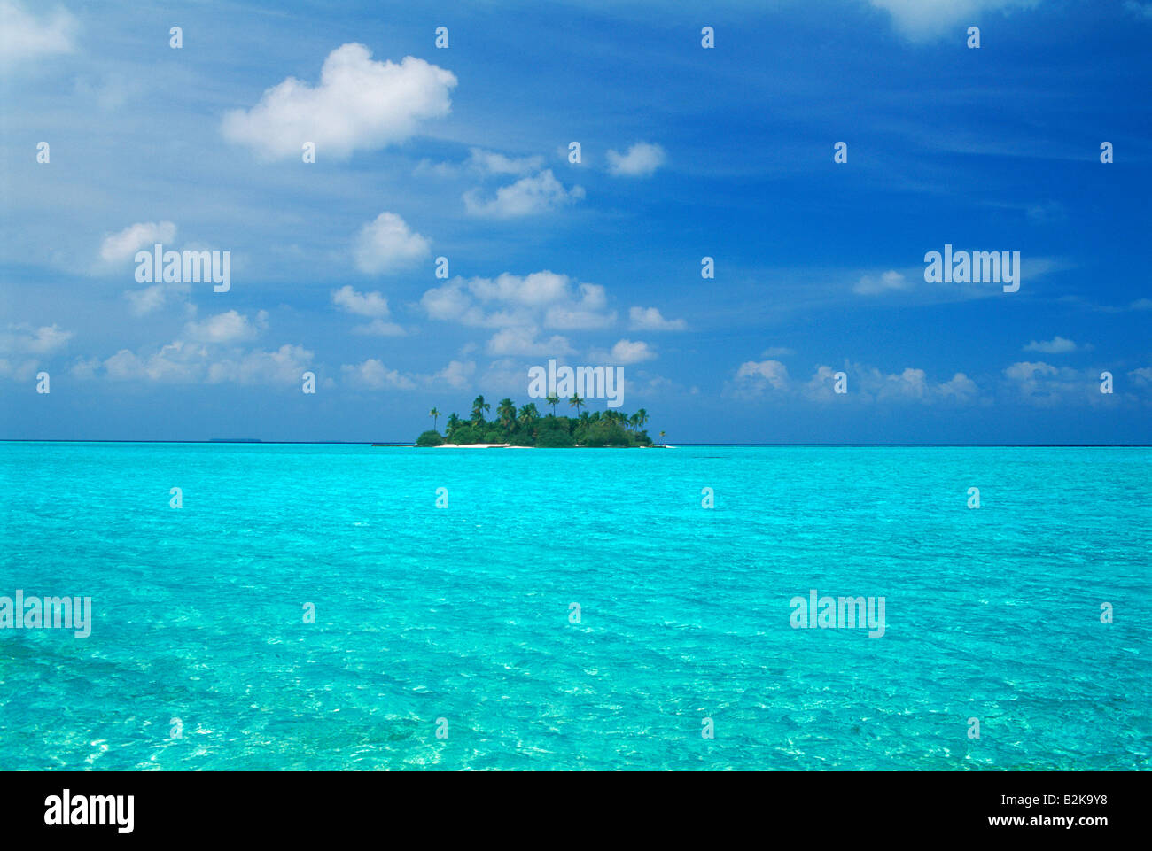 Desert Isle or deserted island in middle of aqua waters representing ...