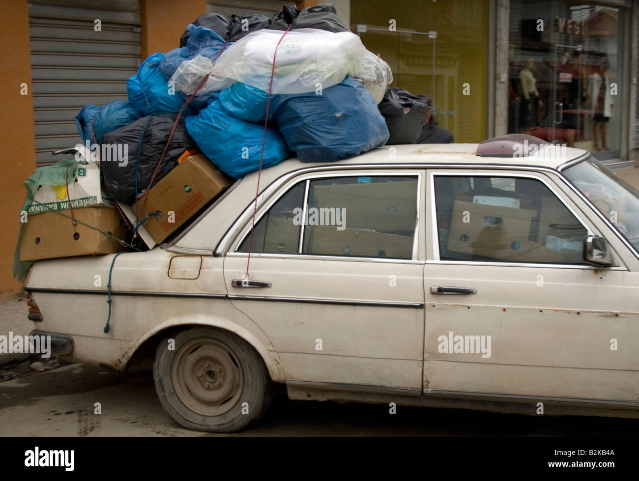 An overloaded car in the city of Shkodra, Albania Stock Photo - Alamy