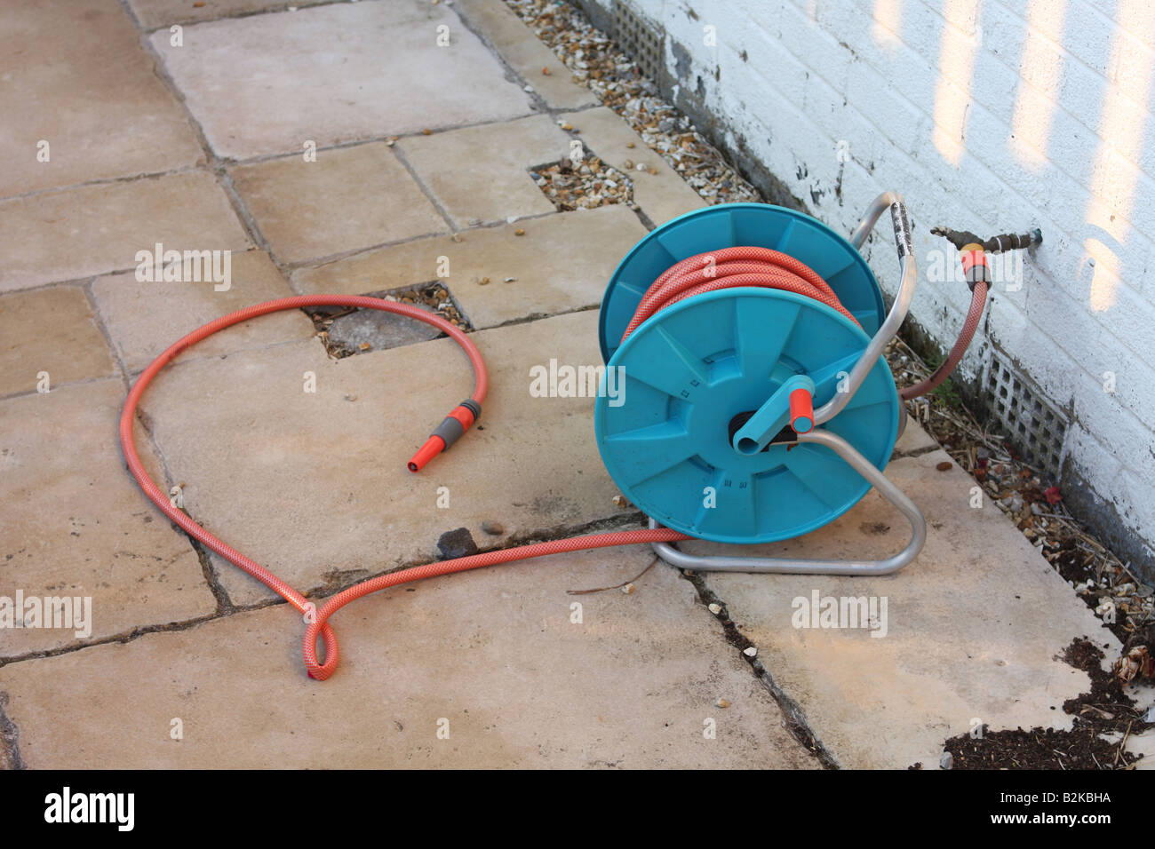 Garden hose on ground Stock Photo - Alamy