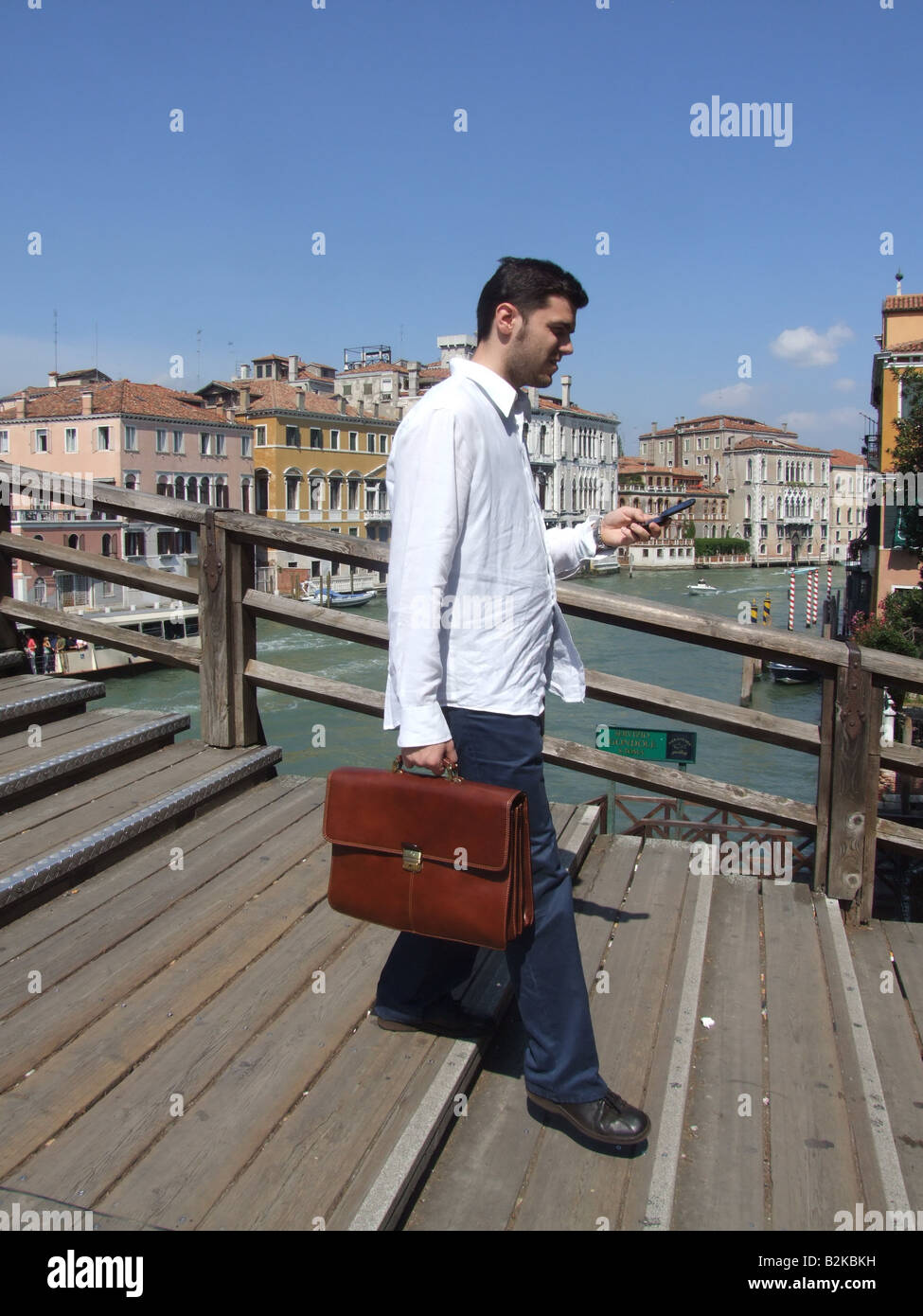 man crossing bridge over canal grande in venice Stock Photo - Alamy