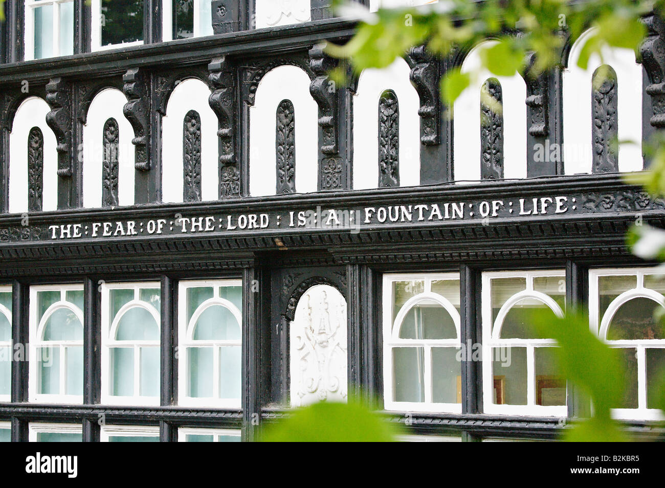Religious motto on the wall of a black and white building in Chester ...