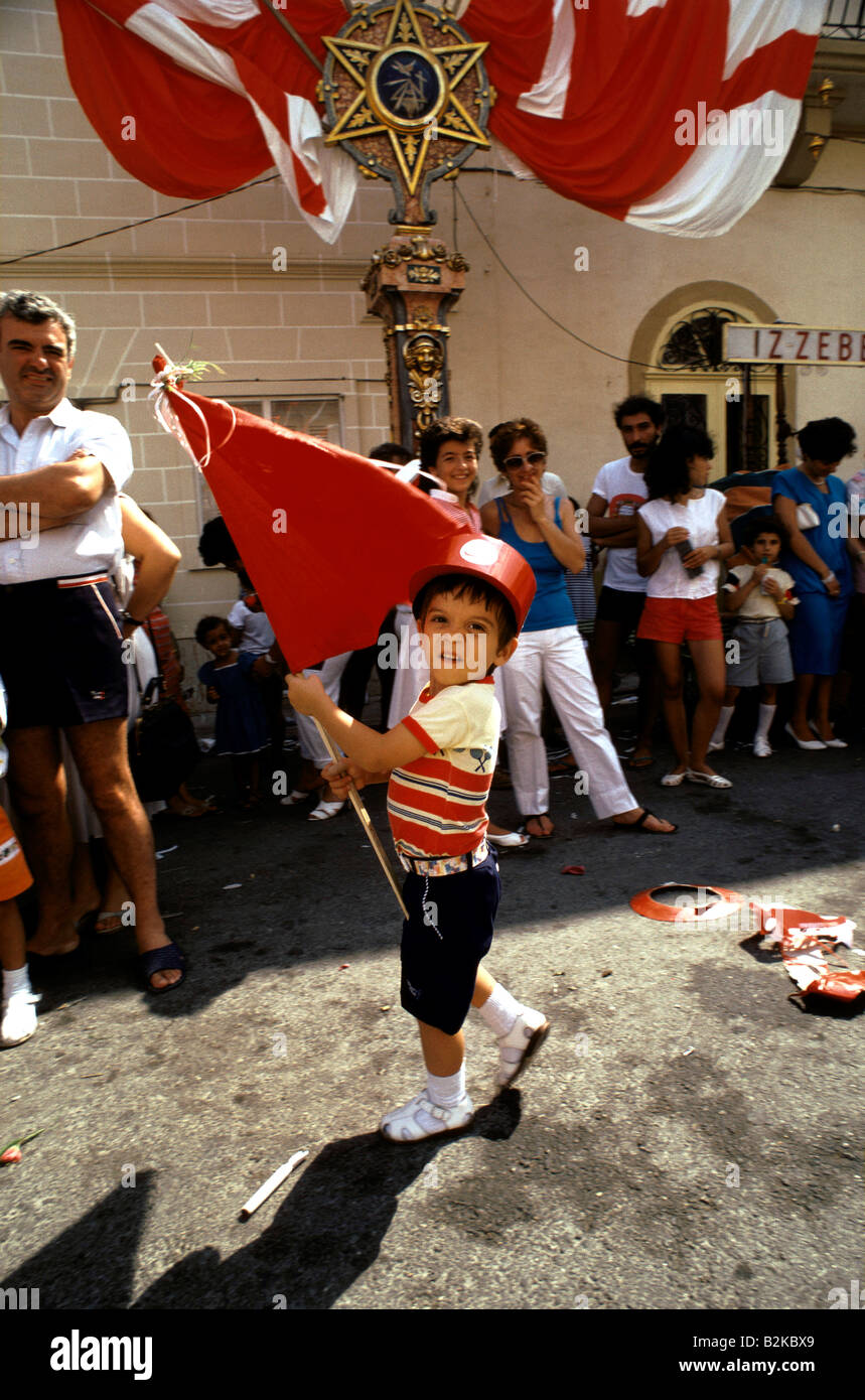 child marching with red flag at a festival malta Stock Photo - Alamy