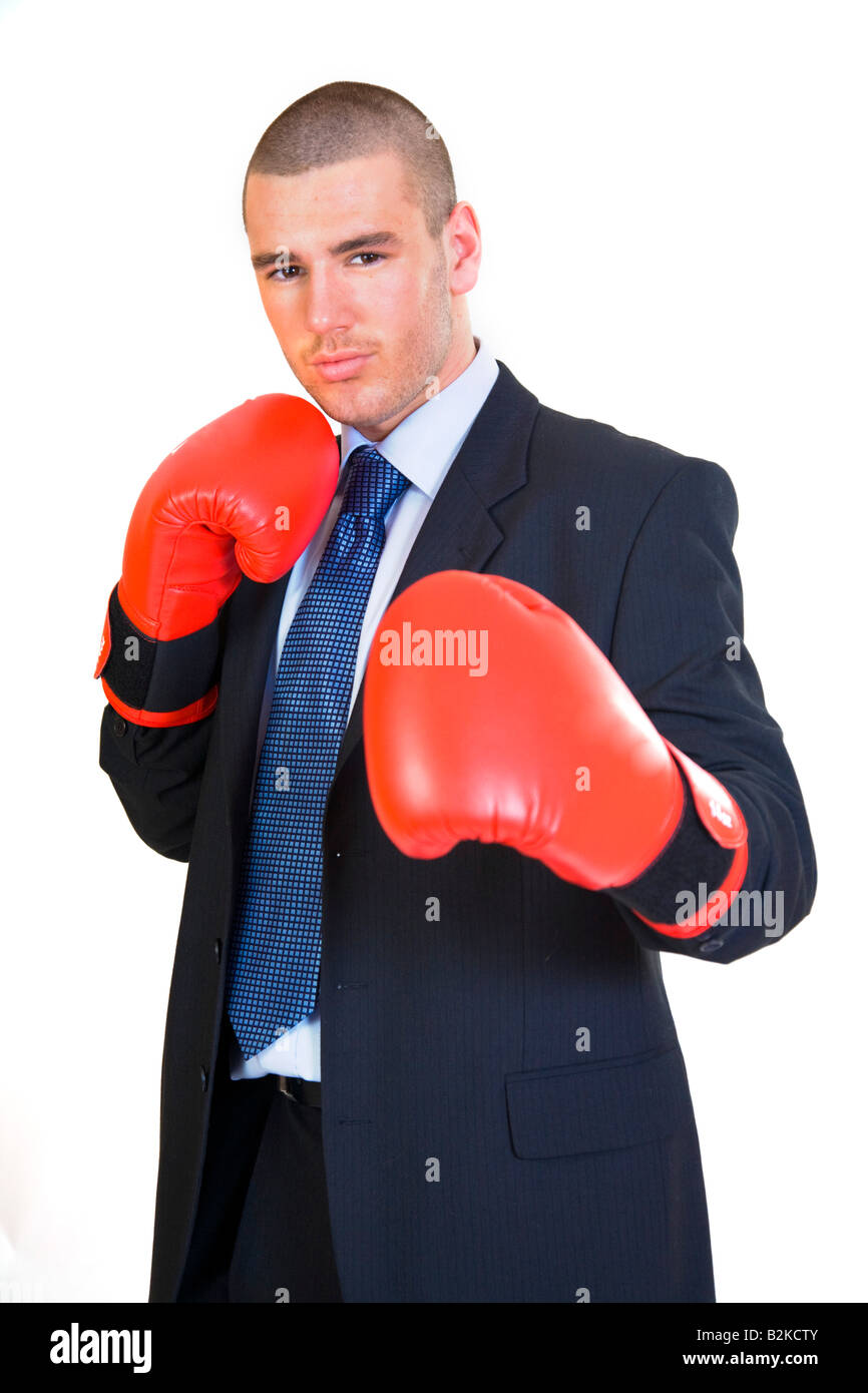 Young man in business suite wearing boxing gloves Stock Photo - Alamy