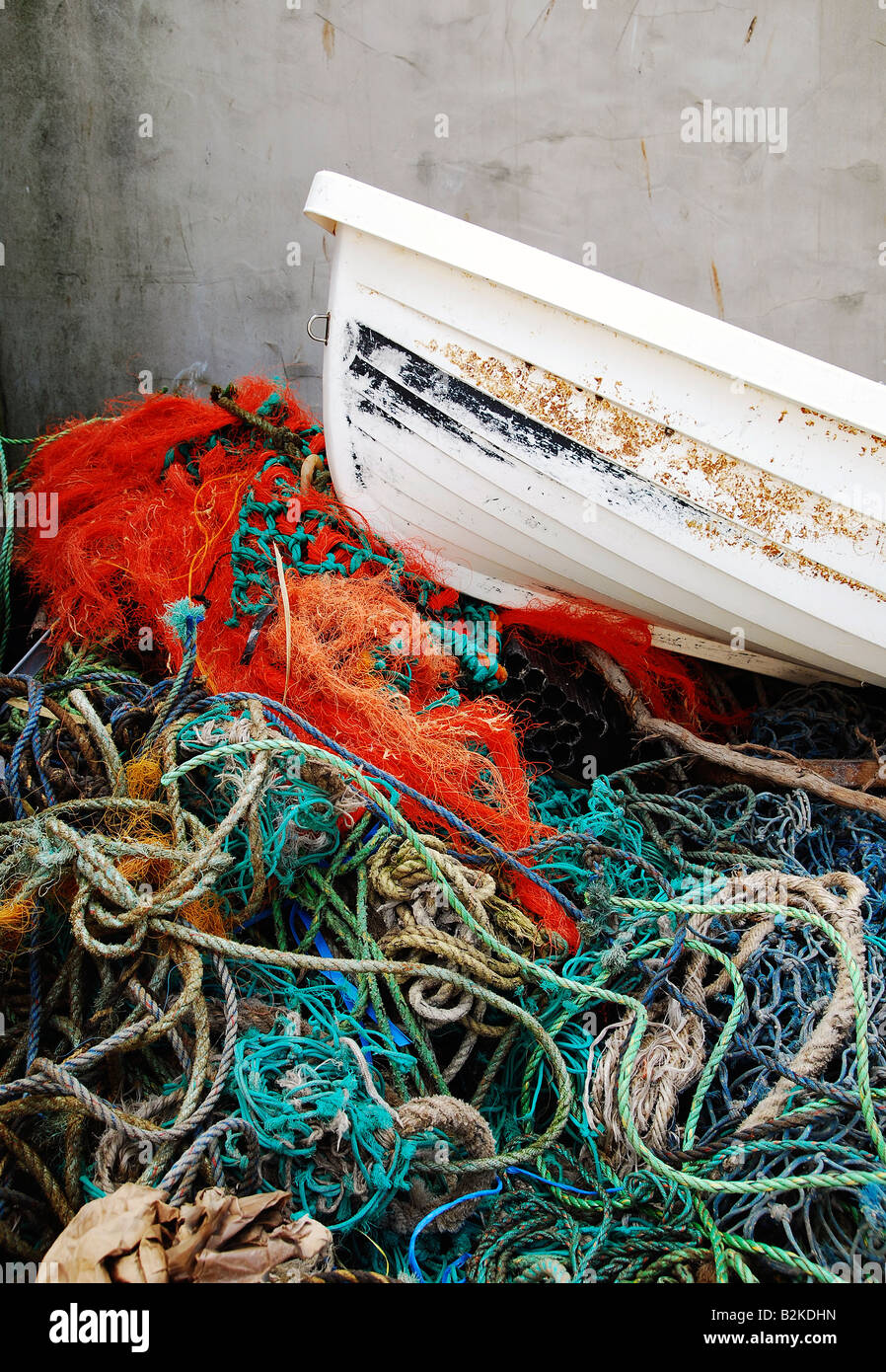 An old boat dumped onto tangled fishing rope Stock Photo - Alamy