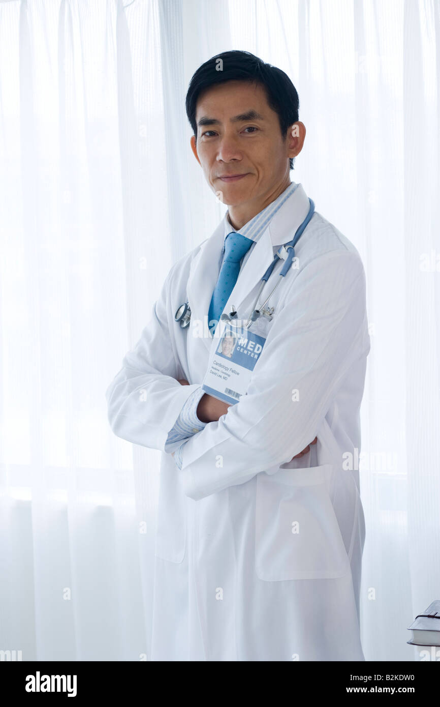 Portrait of a male doctor standing with his arms crossed Stock Photo ...