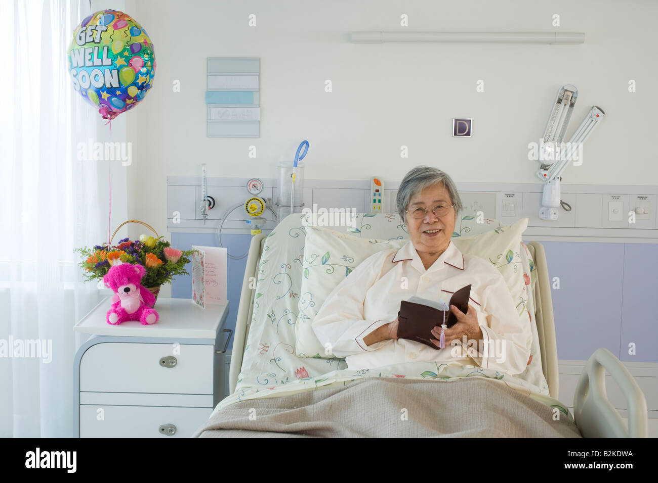 Portrait of a female patient reading a book in the hospital Stock Photo ...