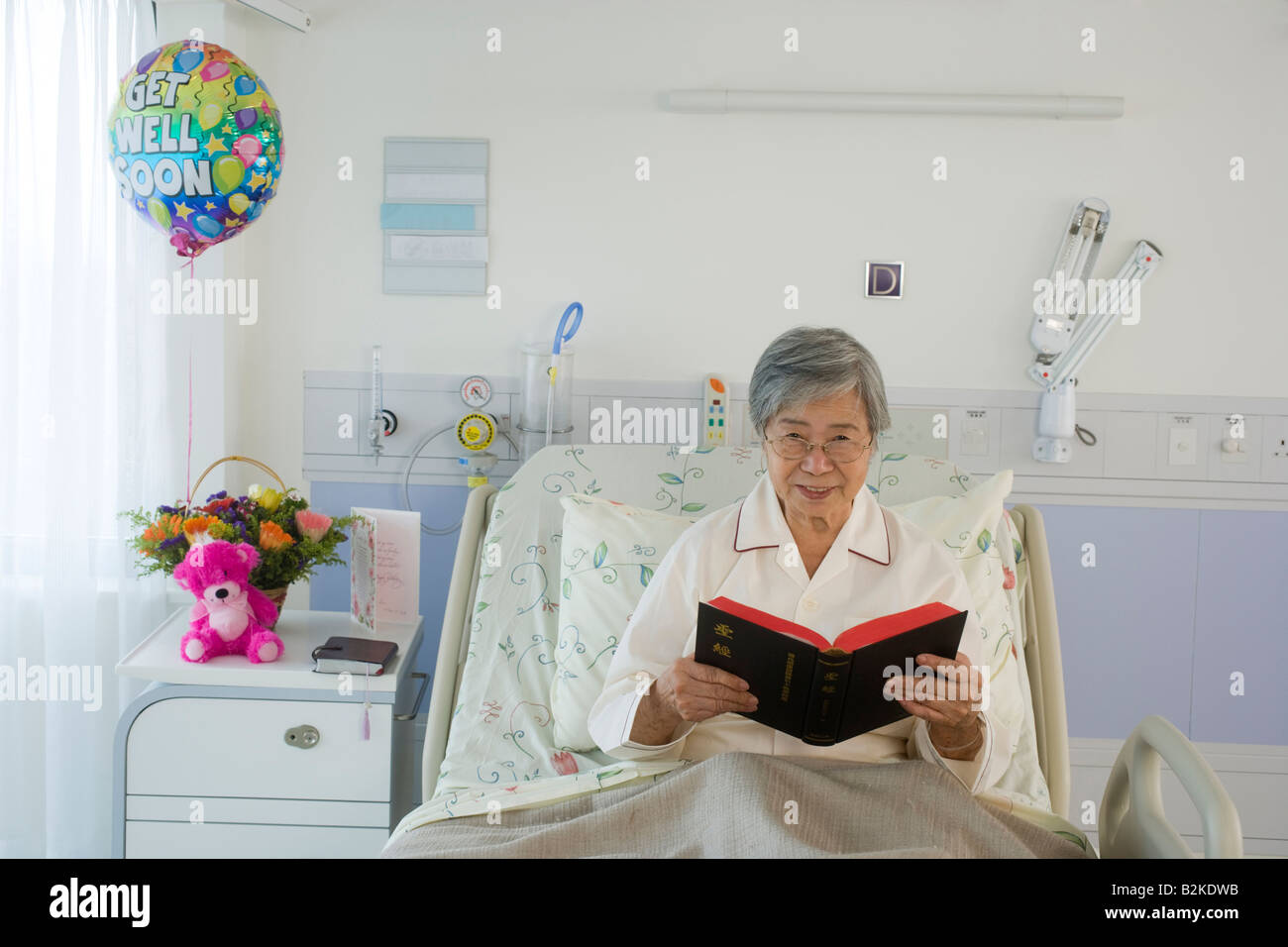 Portrait of a female patient reading a book in the hospital Stock Photo ...