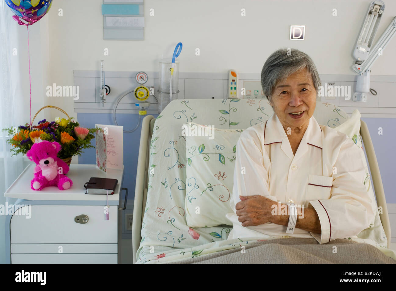 Portrait of a female patient sitting with arms crossed in the hospital ...