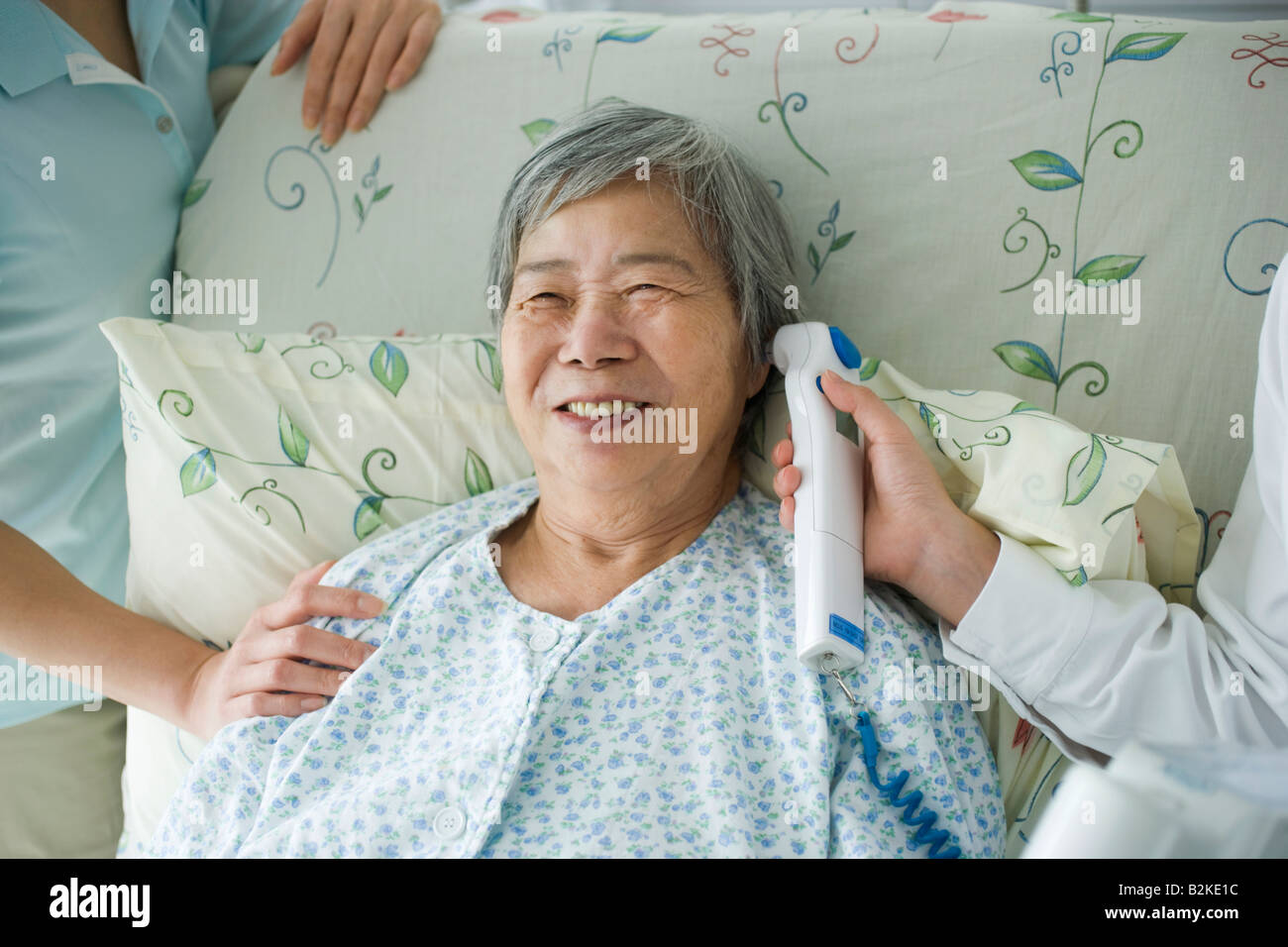 Portrait of a female patient reclining on the bed and smiling Stock ...