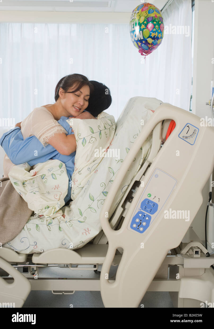 Mid adult couple embracing each other in a hospital room Stock Photo ...