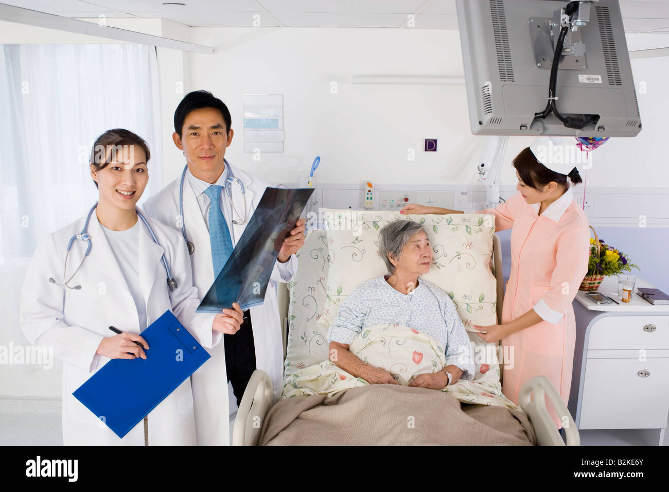 Two doctors and a patient in a hospital room Stock Photo - Alamy