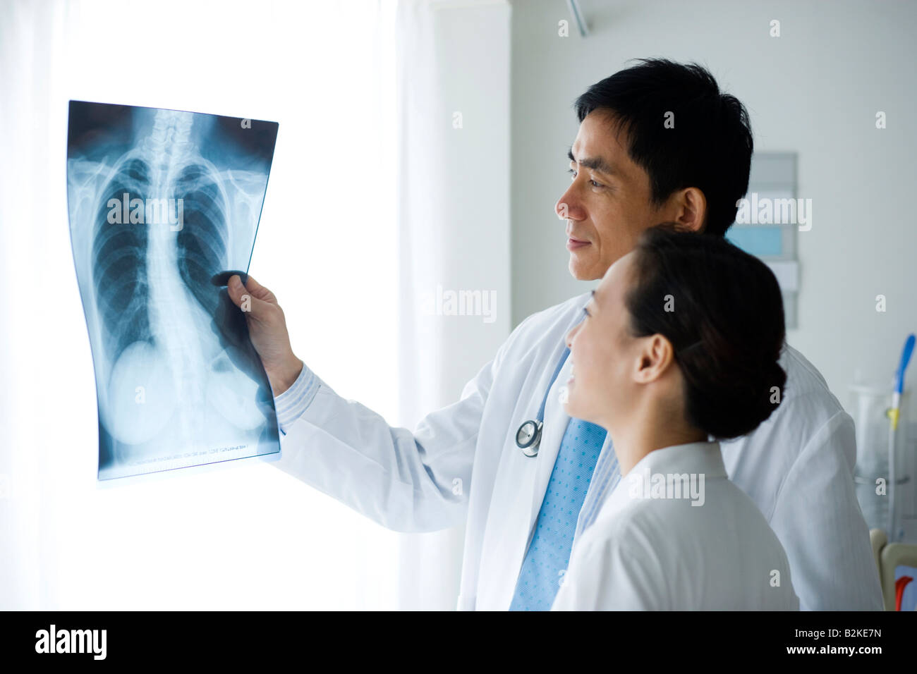 Two doctors examining an X-Ray report Stock Photo - Alamy
