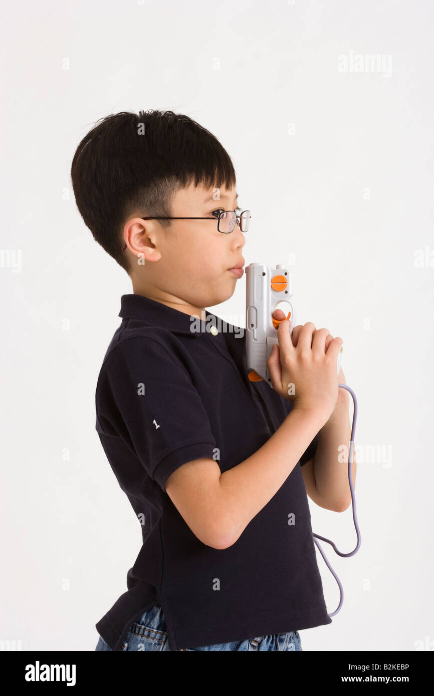 Close-up of a boy holding a video game gun Stock Photo - Alamy