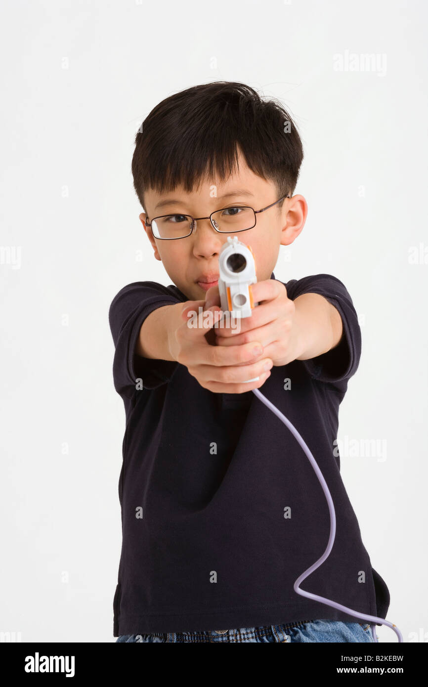 Portrait of a boy playing video game with a gun Stock Photo - Alamy