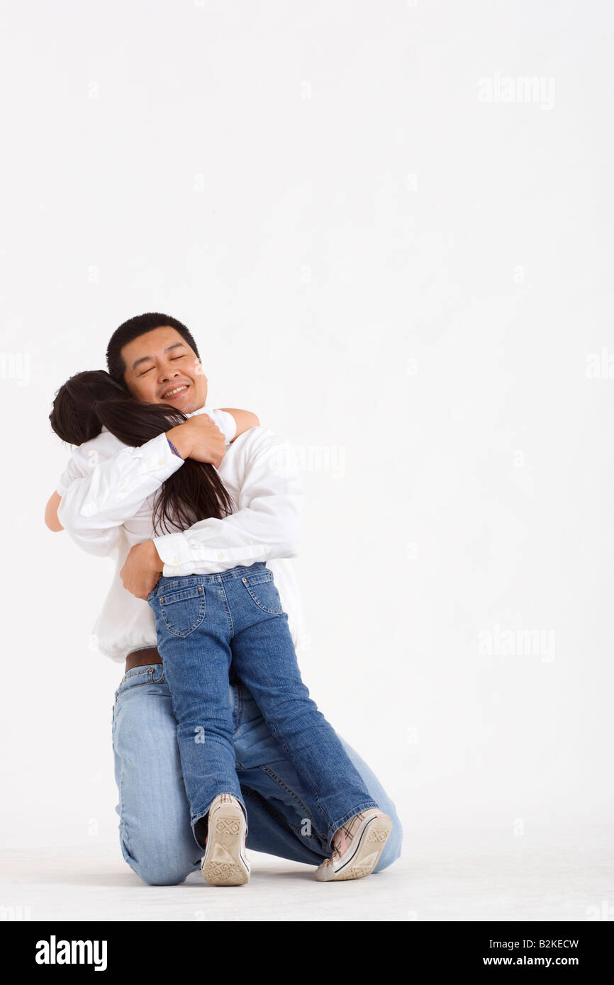 Father hugging his daughter Stock Photo - Alamy