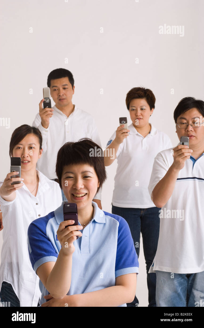 Five people using mobile phones Stock Photo - Alamy