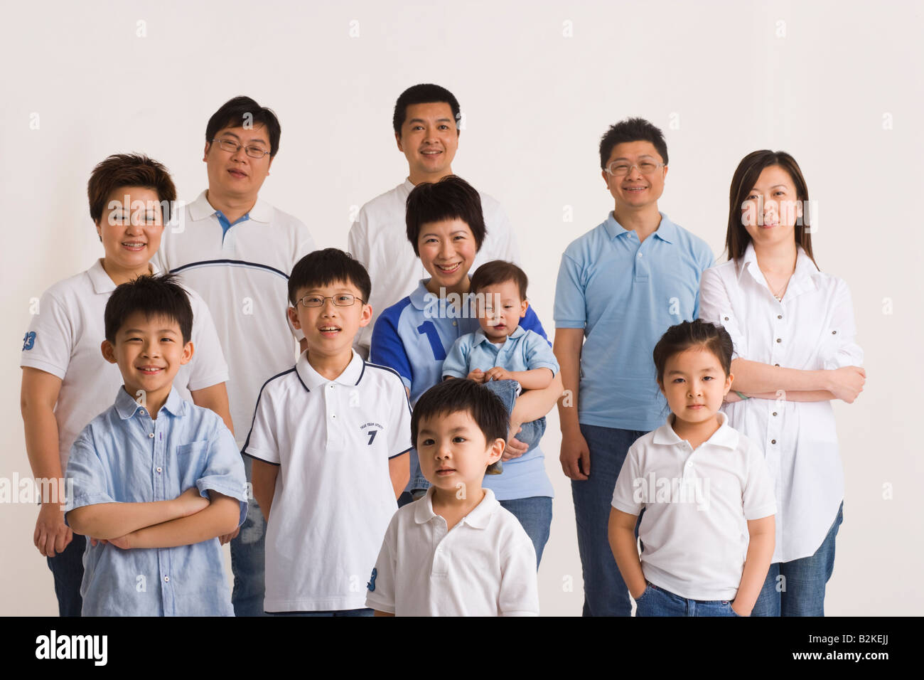 Portrait of three mid adult couples with their children Stock Photo - Alamy