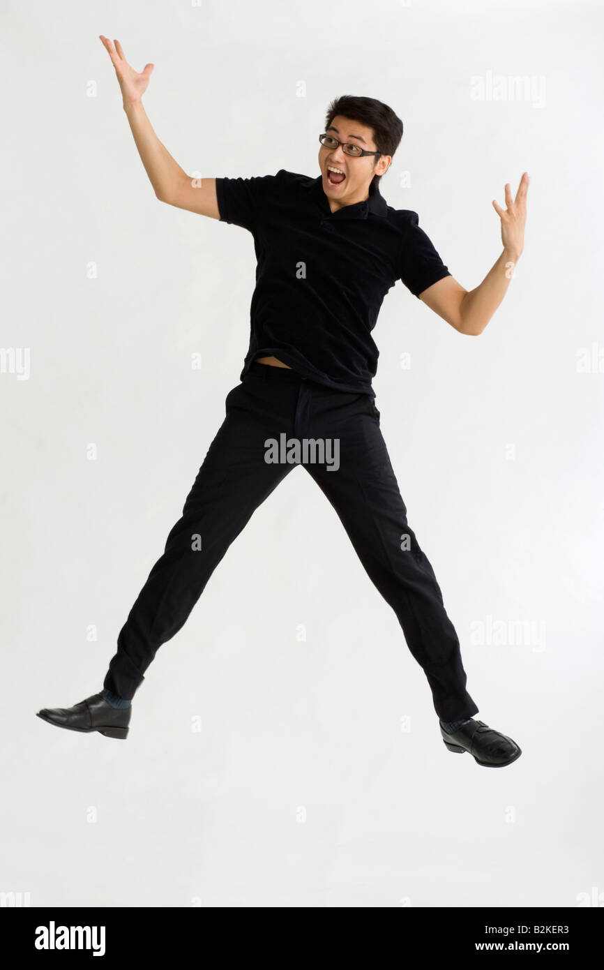 Young man jumping and shouting Stock Photo - Alamy