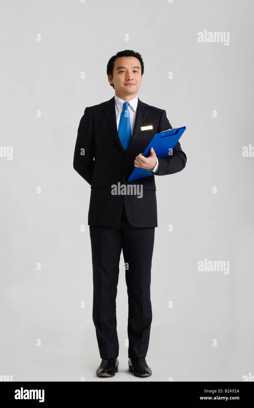 Portrait of a businessman holding a clipboard Stock Photo - Alamy
