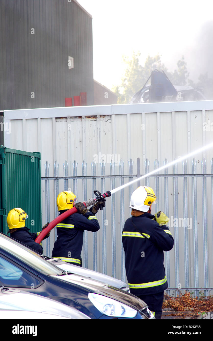 UK Fire crew battling a blaze Stock Photo - Alamy