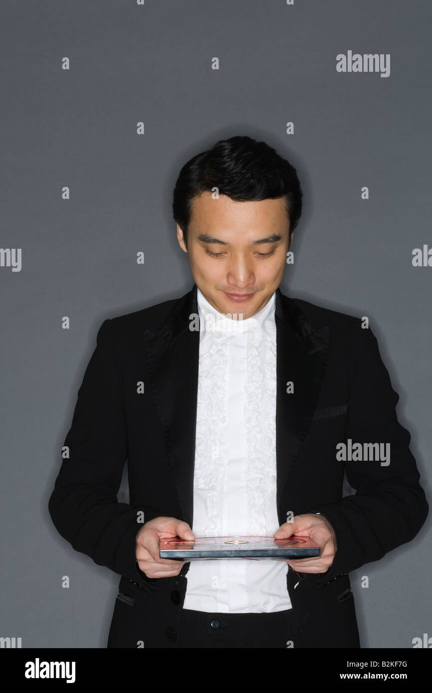 Close-up of a young man holding a Luo Pan and smiling Stock Photo - Alamy