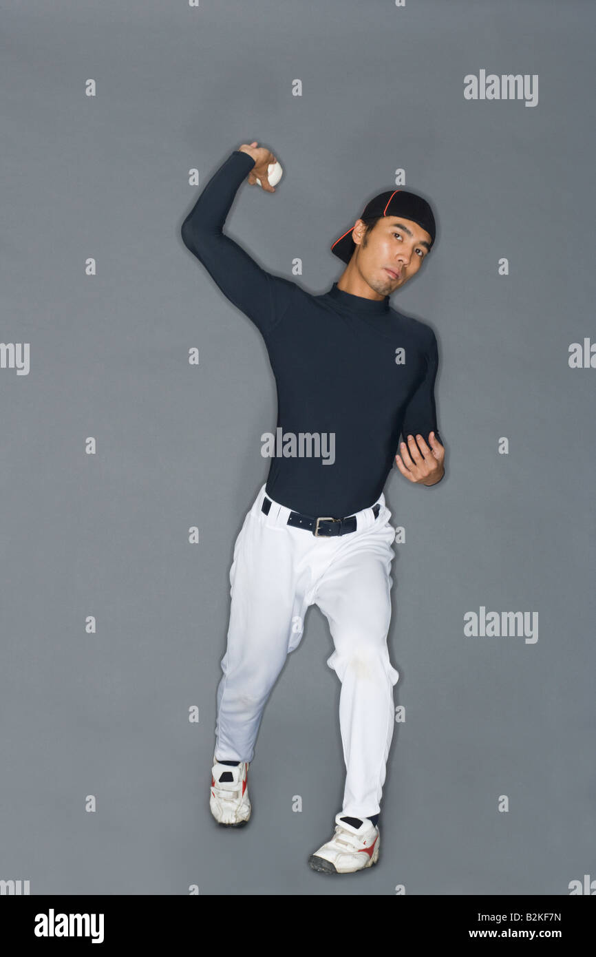 Portrait of a young man throwing a baseball Stock Photo - Alamy