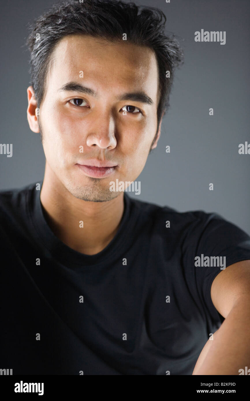 Portrait of a young man thinking Stock Photo - Alamy