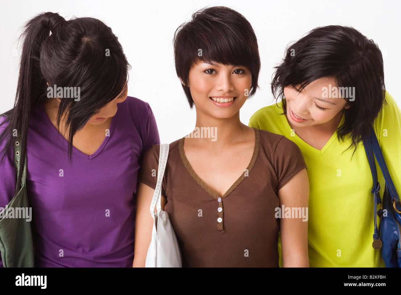 Three young women standing together and smiling Stock Photo - Alamy