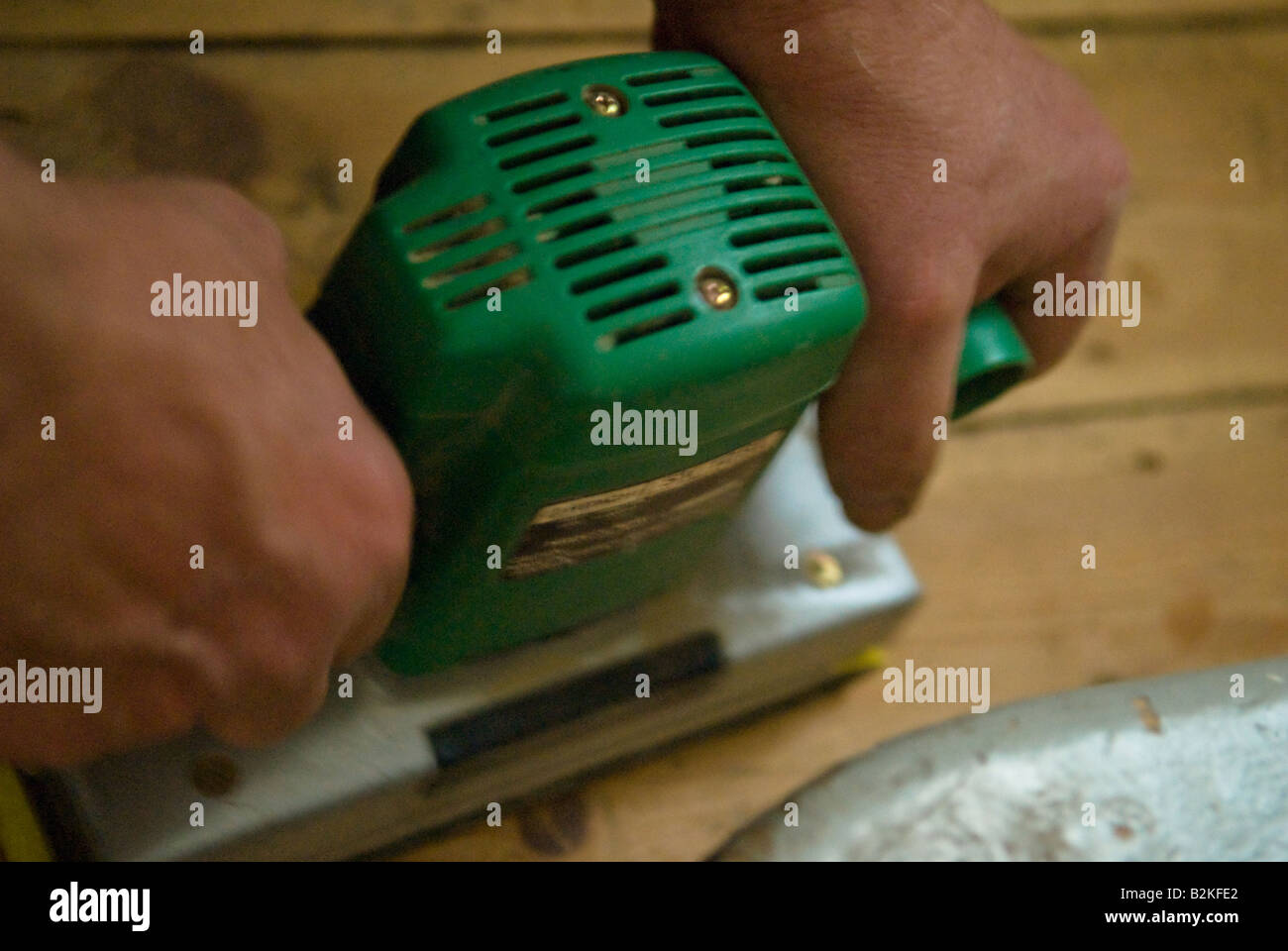 Sanding wooden boards with an orbital sander Stock Photo - Alamy
