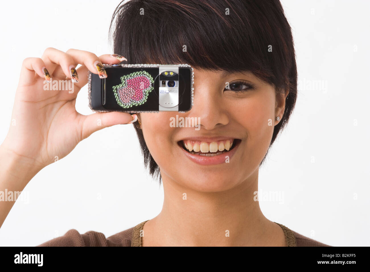 Portrait of a young woman photographing with a camera phone Stock Photo ...