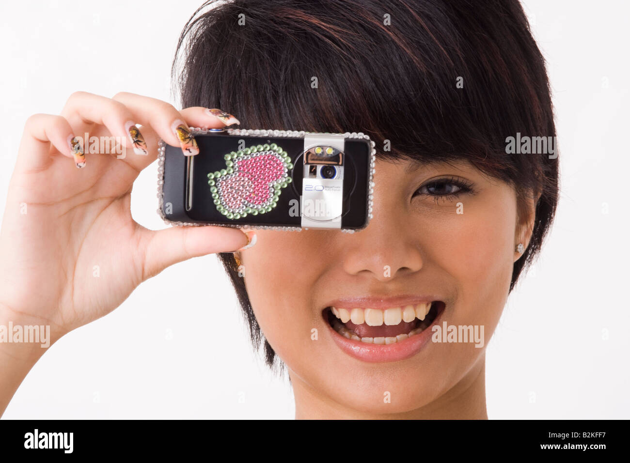 Portrait of a young woman photographing with a camera phone Stock Photo ...