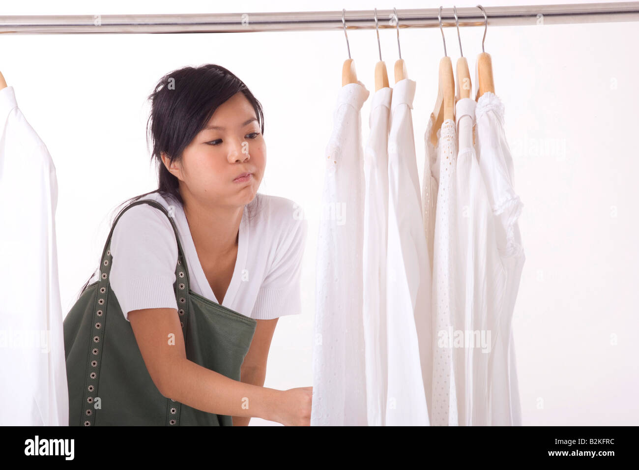 Young woman shopping in a clothing store Stock Photo - Alamy