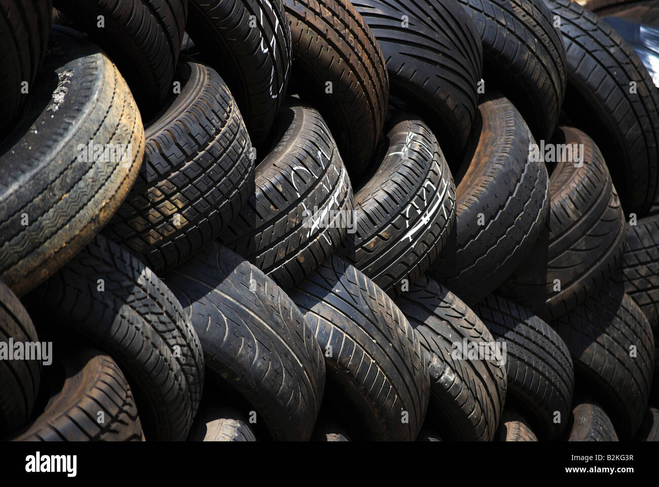 Tyres stacked for recycling Stock Photo - Alamy