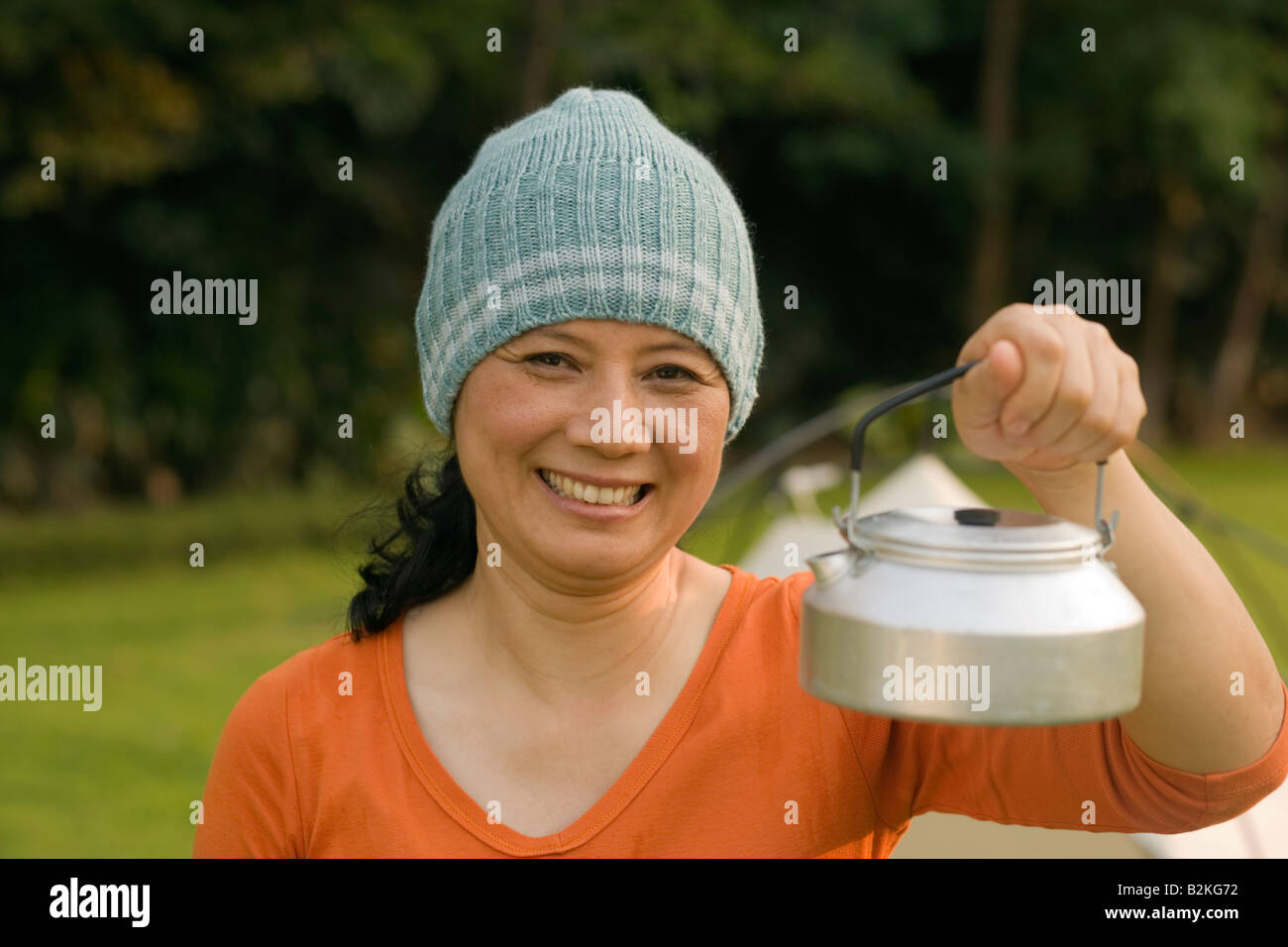 Cheerful woman tea kettle hi-res stock photography and images - Alamy