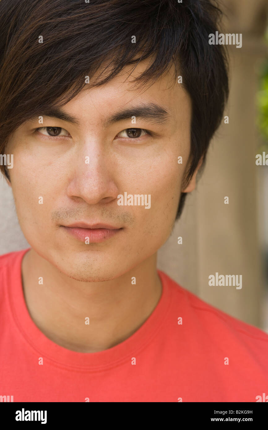 Portrait of a young man looking serious Stock Photo - Alamy