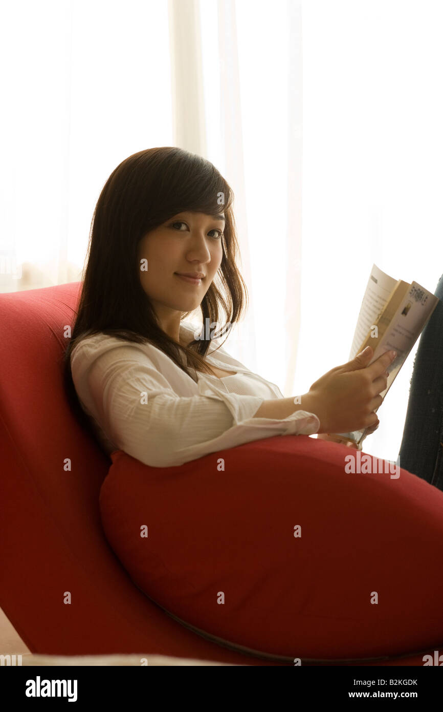 Reclining asian woman reading hi-res stock photography and images - Alamy