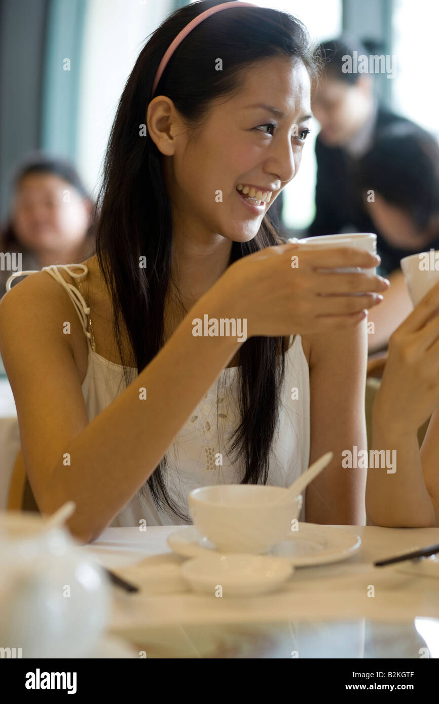 Close-up of a young woman having tea in a restaurant Stock Photo - Alamy