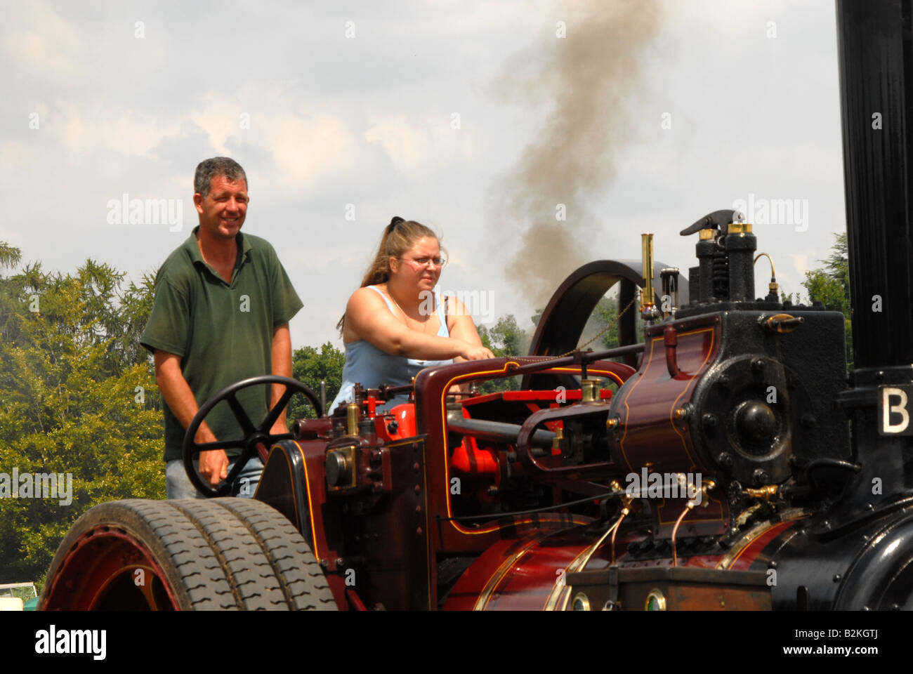 Two people driving a steam engine Stock Photo - Alamy