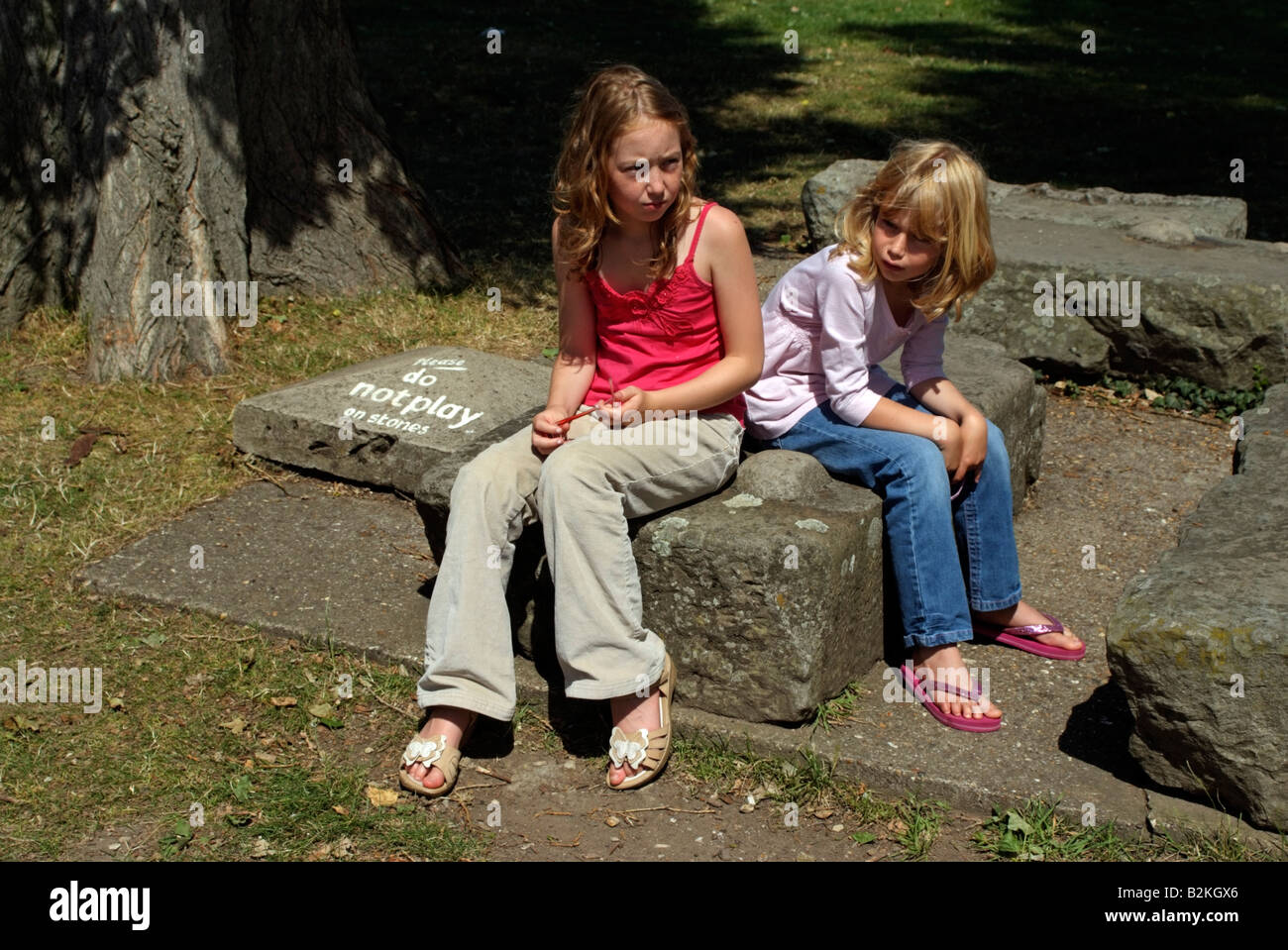 Please Do Not Play on the Stones says the sign and two unhappy girls ...
