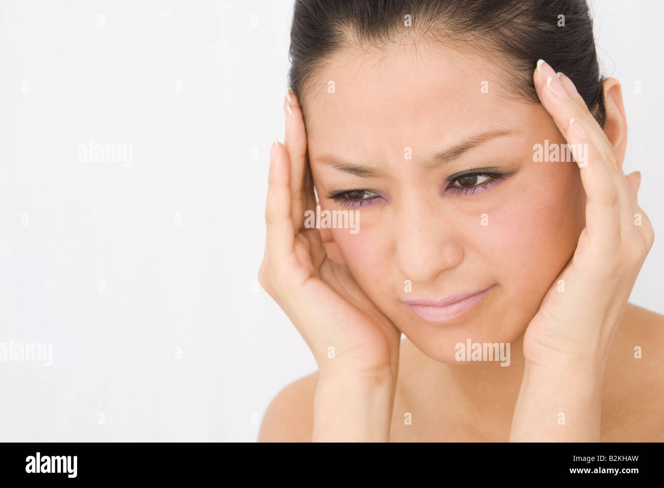 Close-up of a young woman massaging her temples Stock Photo - Alamy