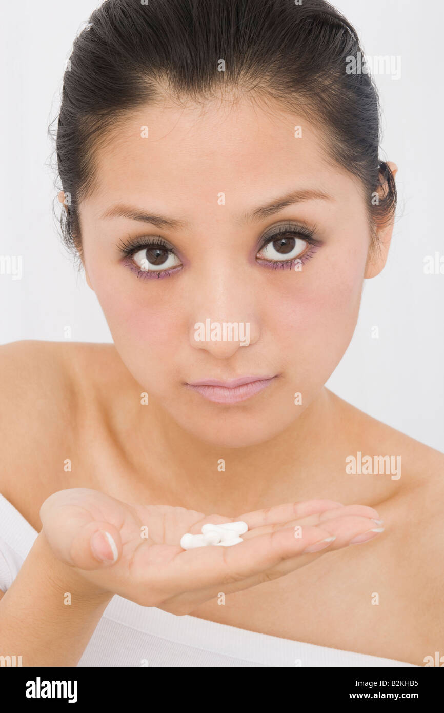 Young woman taking tablet pill face hi-res stock photography and images ...