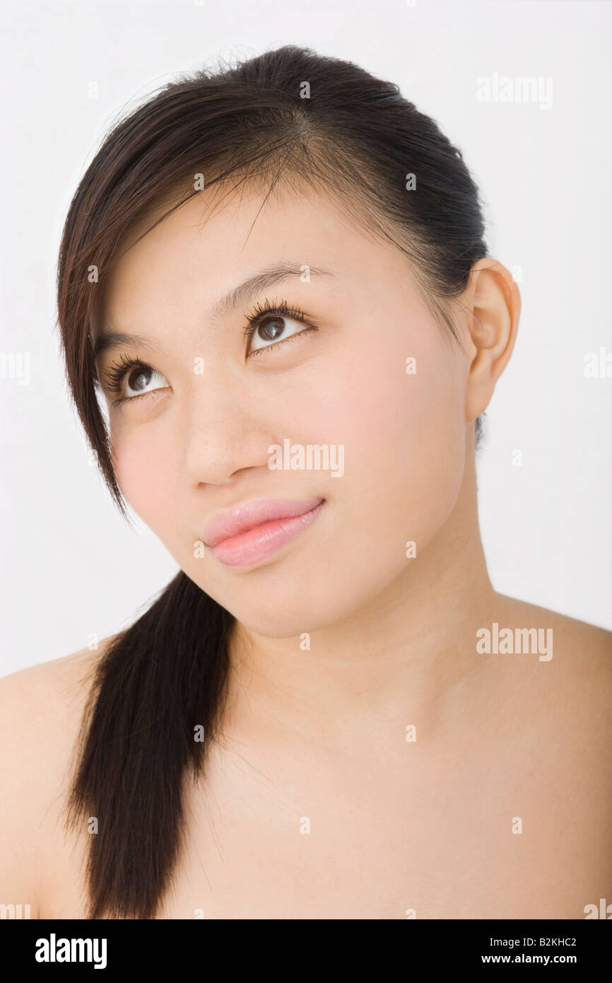 Close-up of a young woman thinking Stock Photo - Alamy