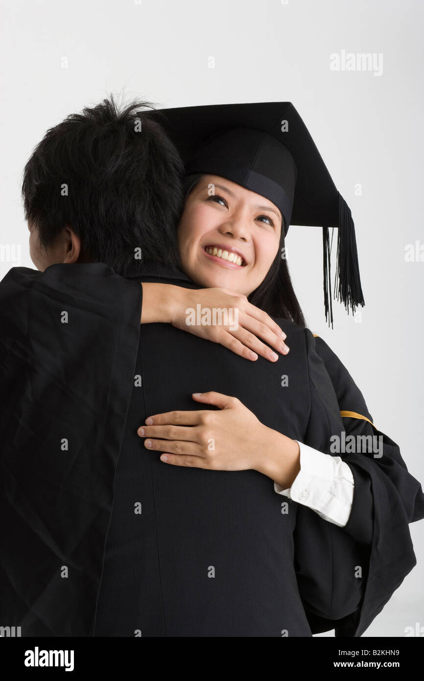 Young female graduate hugging a young man and smiling Stock Photo - Alamy