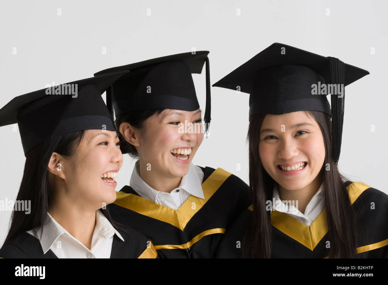 Close-up of three young female graduates smiling together Stock Photo ...